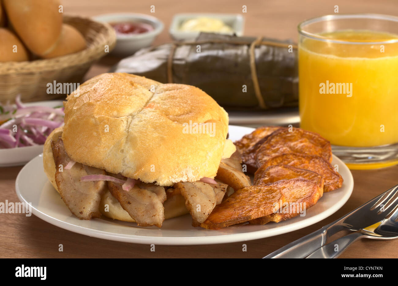 Typical Peruvian breakfast consisting of Pan con Chicharron (Bun with ...