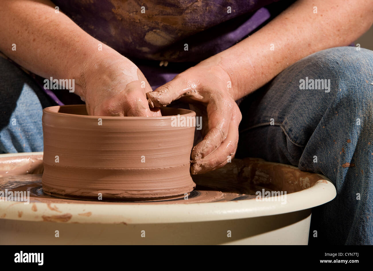 Potter shaping clay on a turning wheel Stock Photo - Alamy