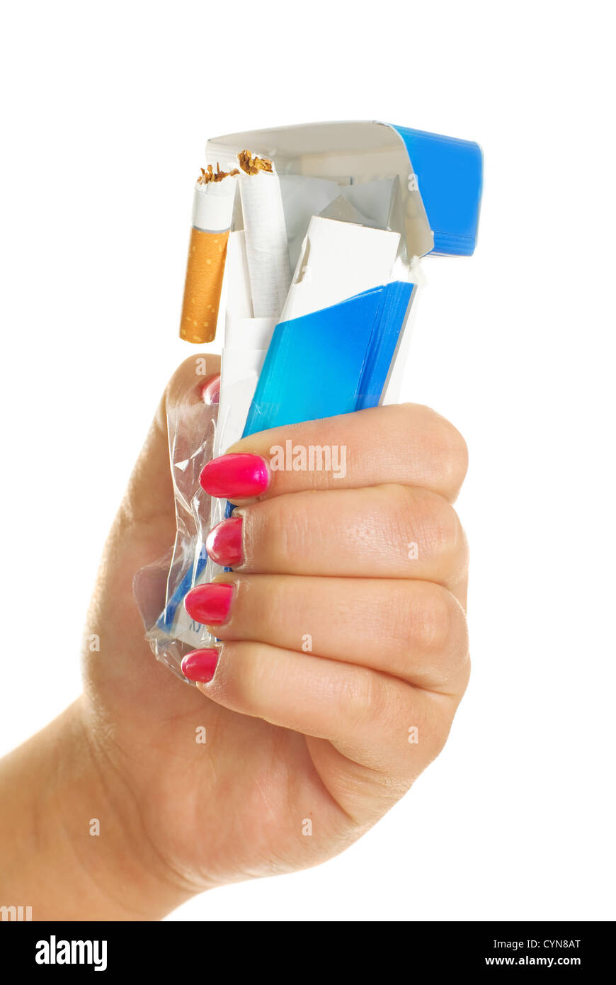 closeup of the hand of a young woman rumpling a pack of cigarettes ...