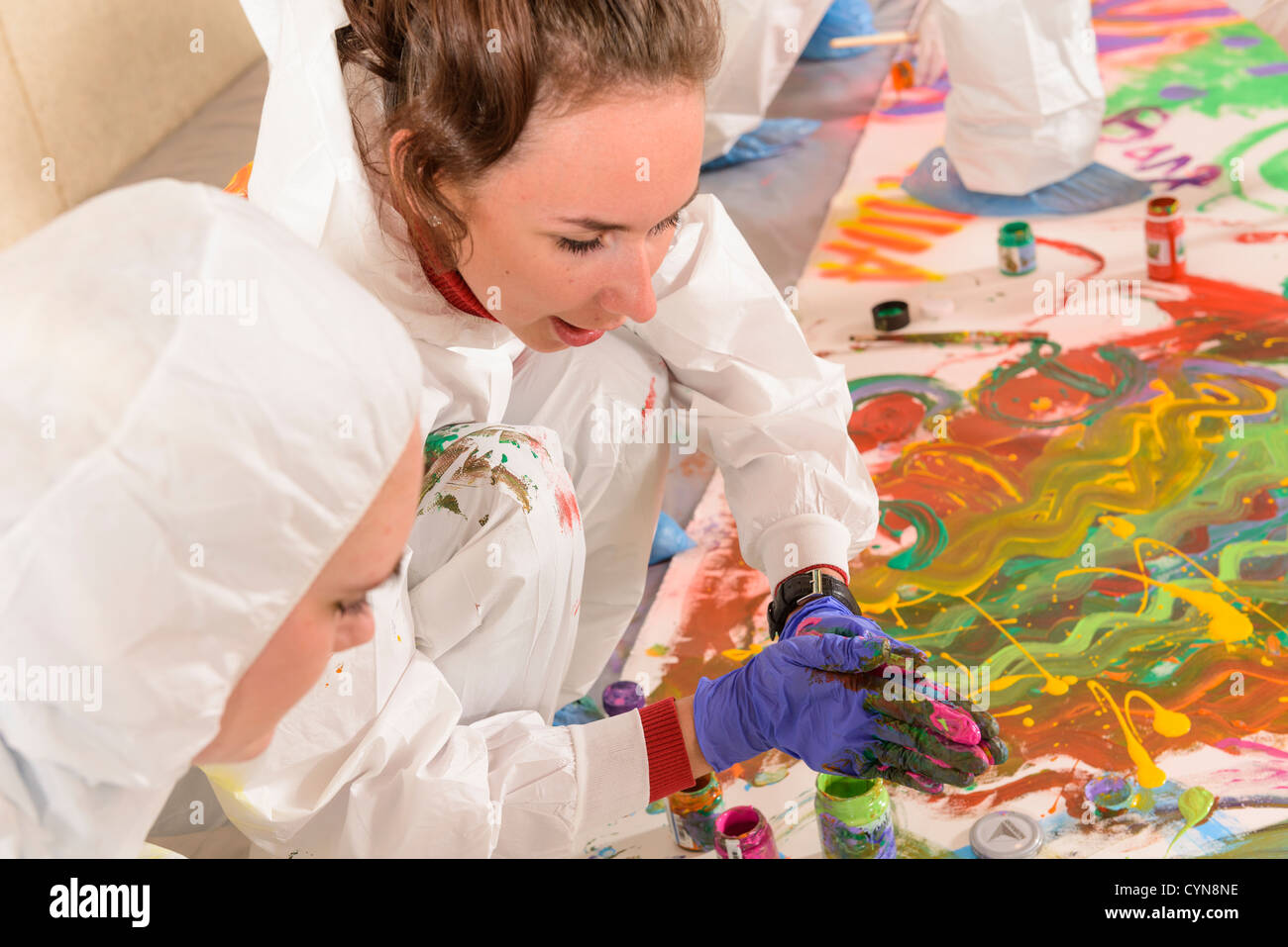 People having fun during art therapy session drawing paint Stock Photo ...
