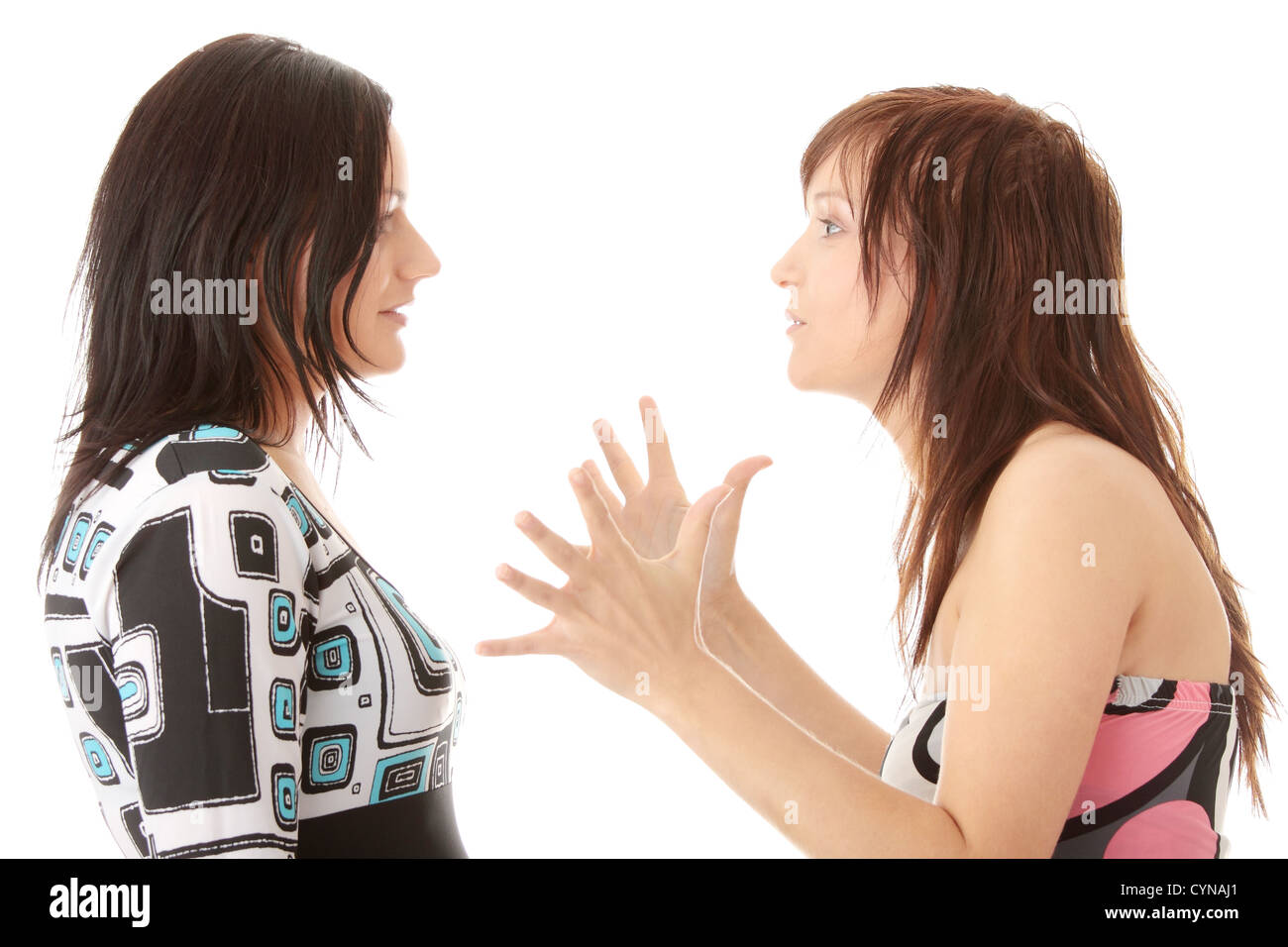 Two young womans arguing, isolated on white background Stock Photo - Alamy