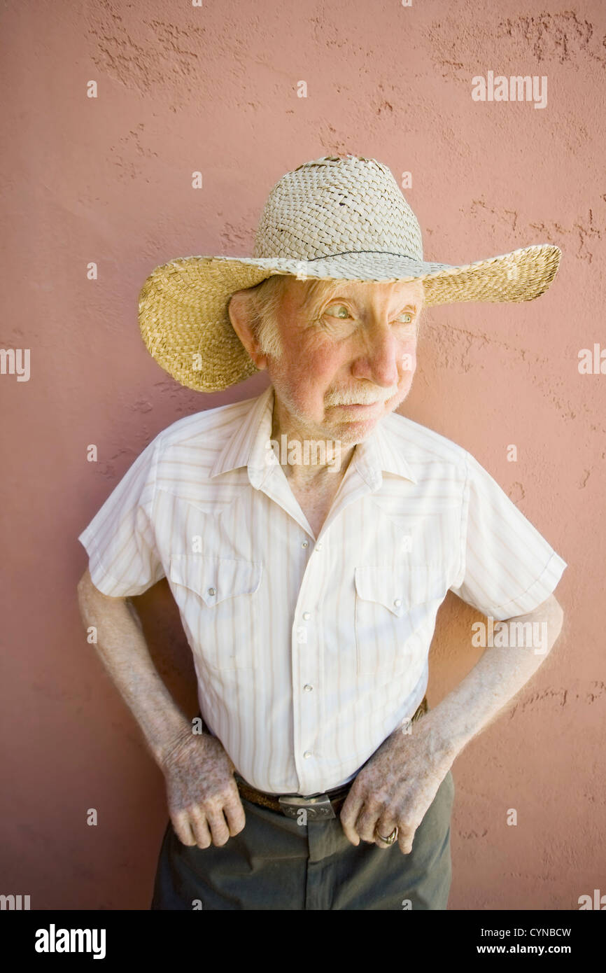 Senior Citizen Man Wearing a Straw Cowboy Hat Looks Off Stock Photo - Alamy