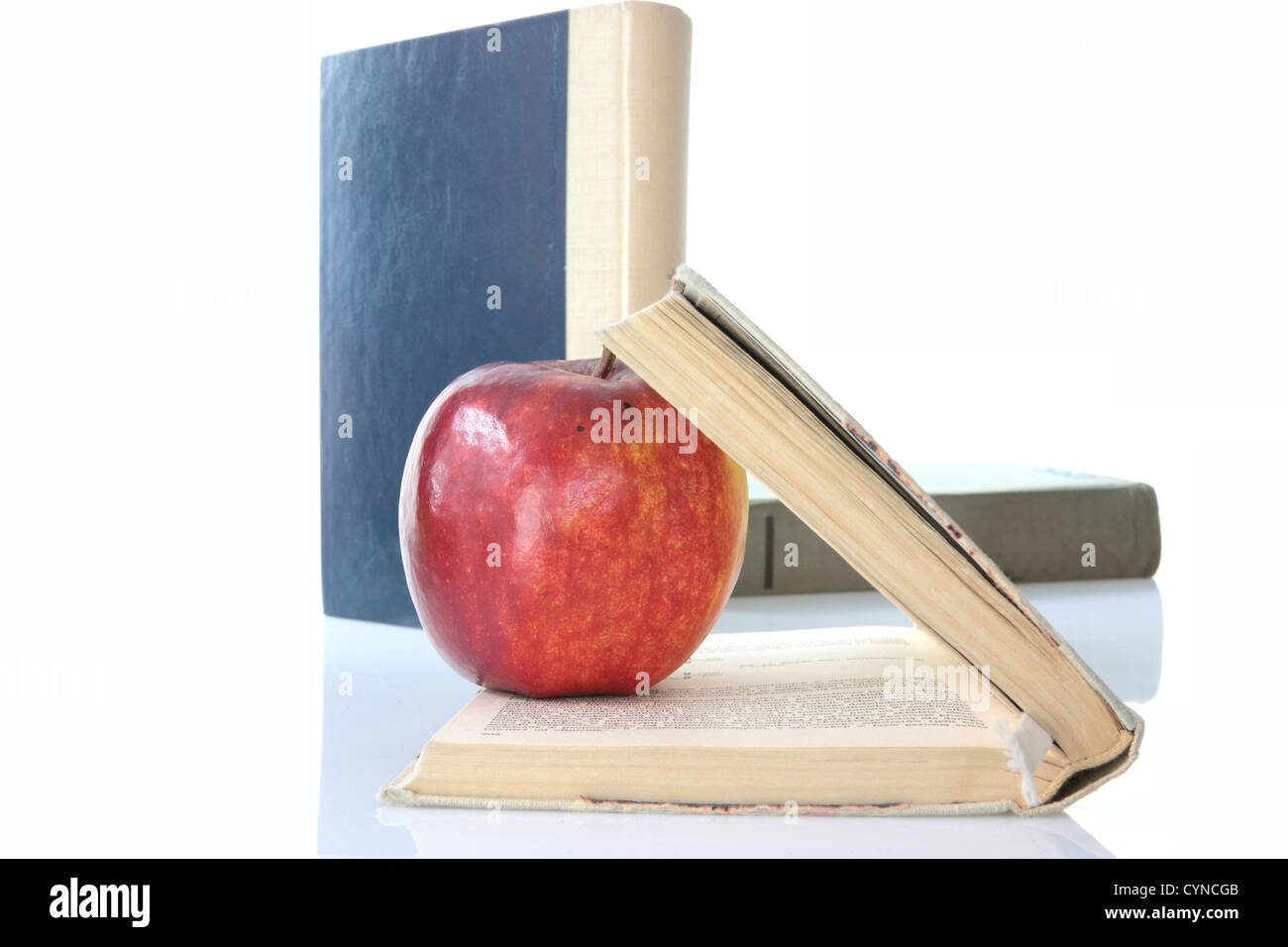 Red apple on books isolated on white Stock Photo - Alamy