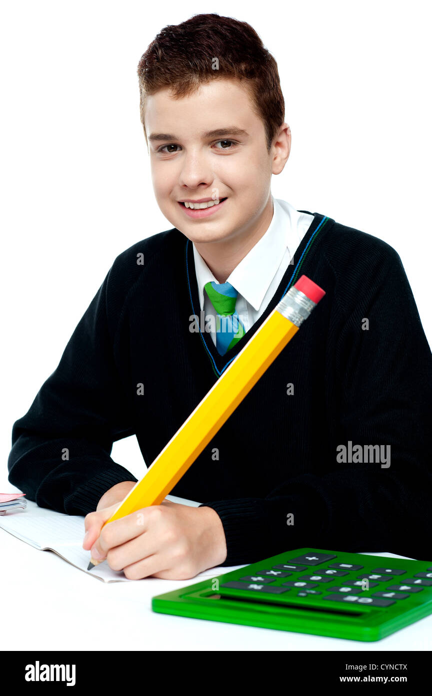 Boy doing homework with calculator beside him isolated against white ...