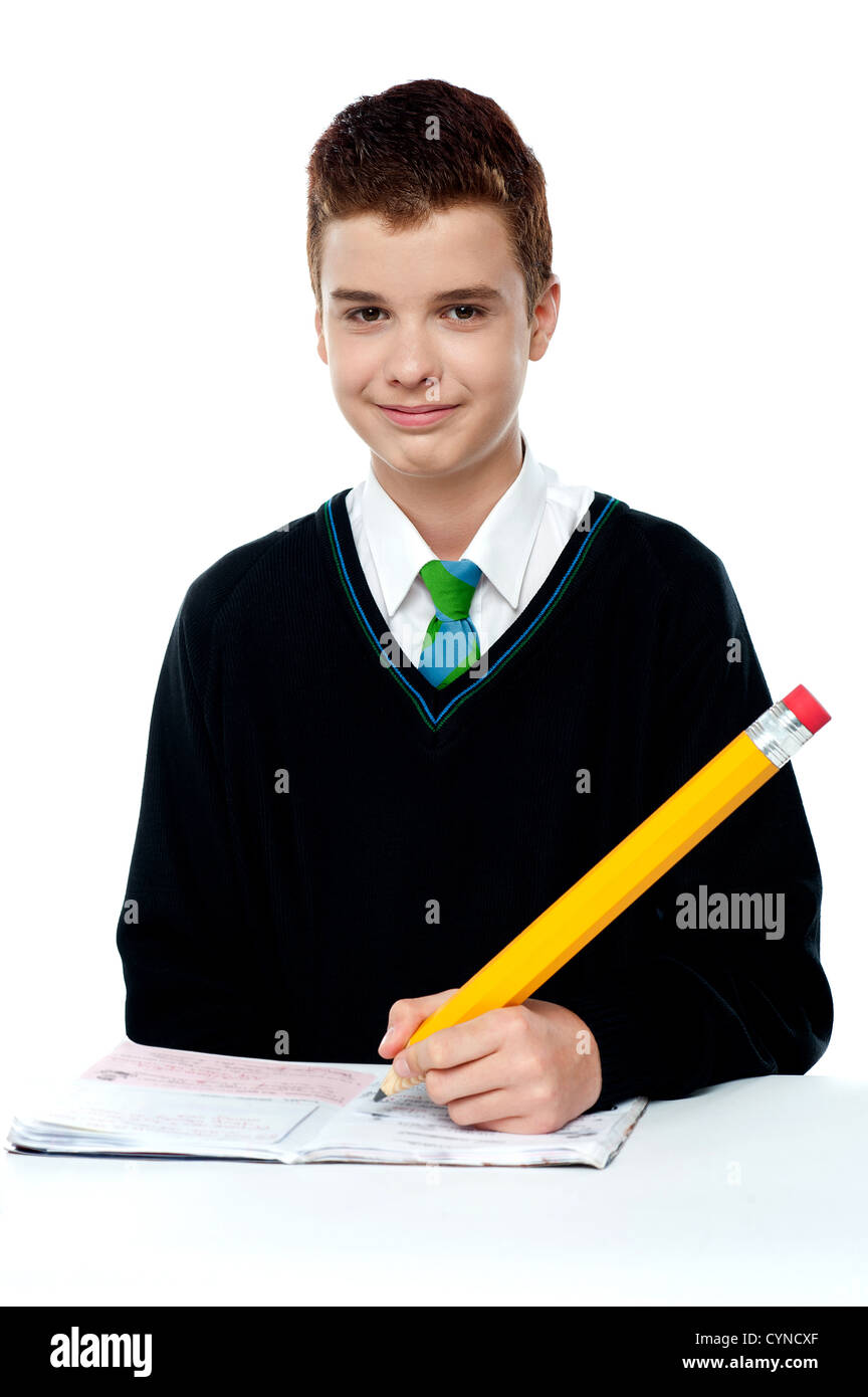 School boy writing on notebook with big yellow color pencil Stock Photo ...