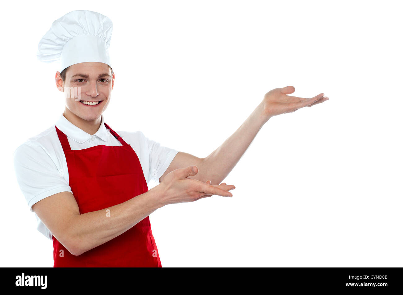 Male chef in red uniform presenting copy space isolated over white ...