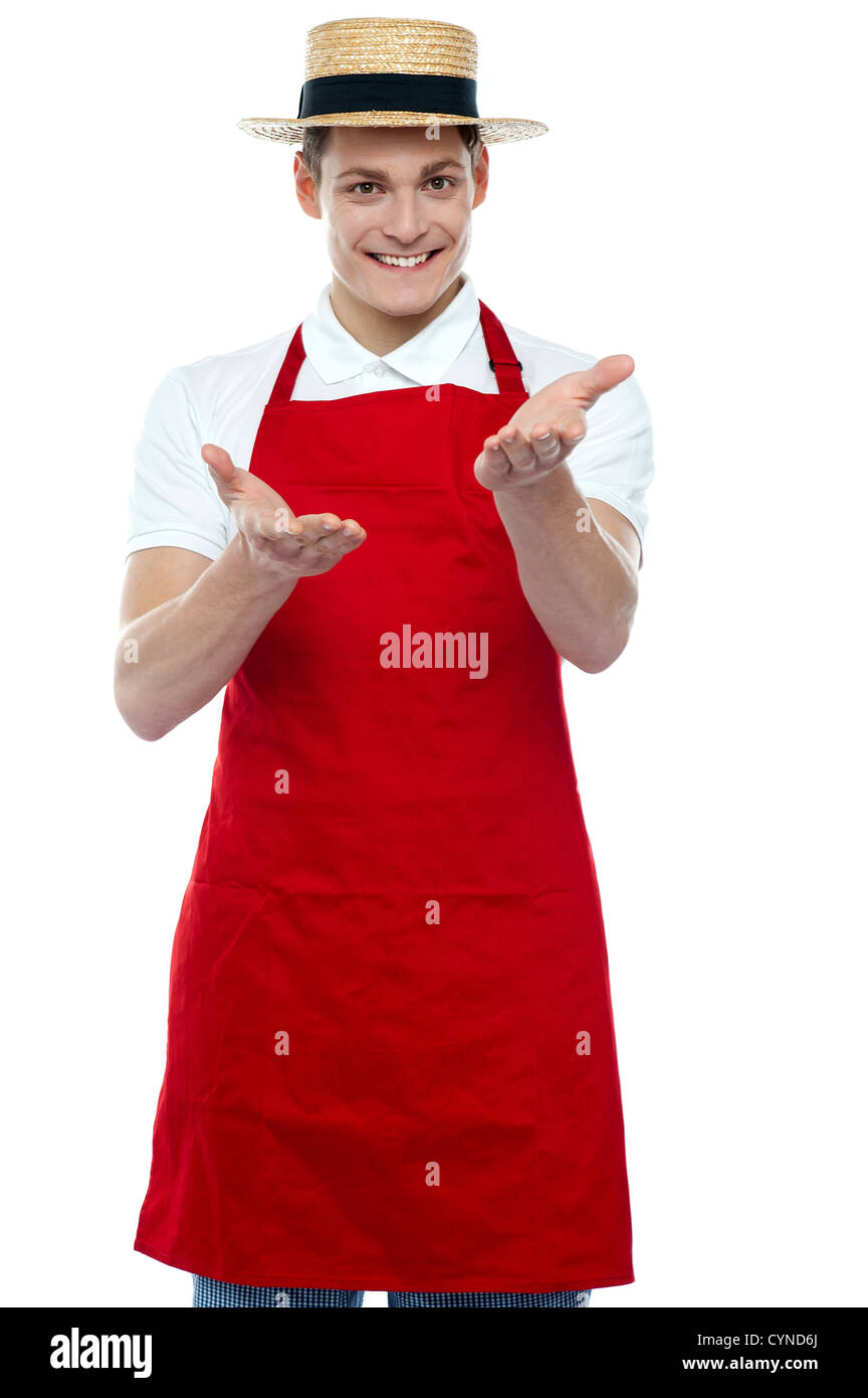 Handsome young male chef welcoming with smile over white background ...