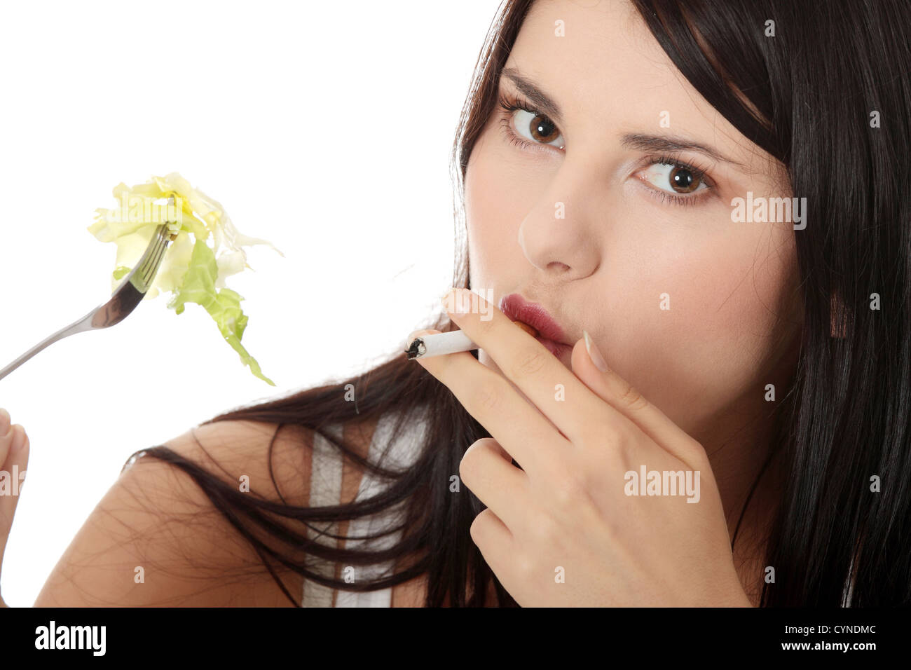Girl eating salad and smoking sigarette. Unhealthy life concept Stock ...