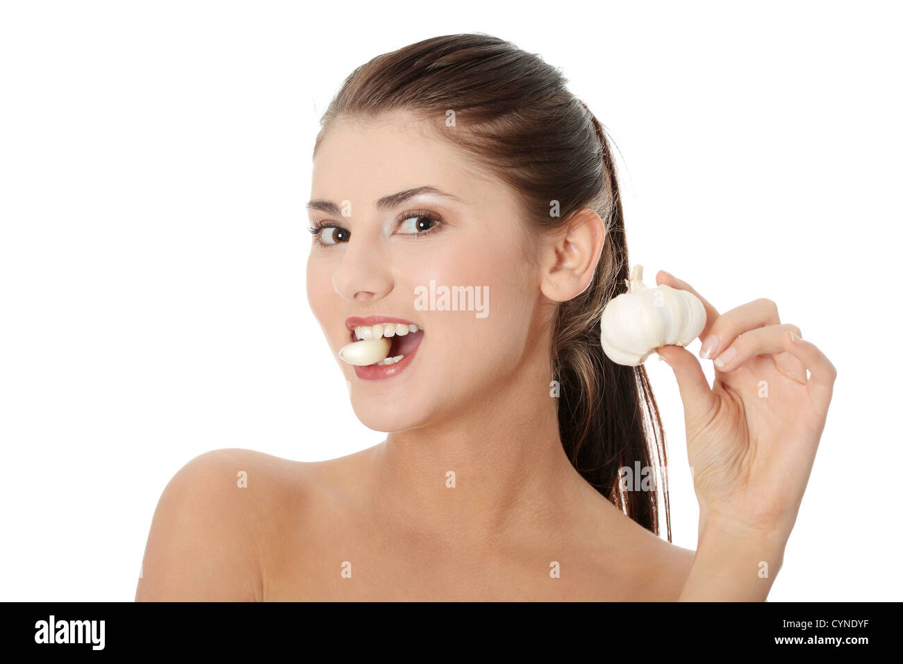 Young beautiful woman eating garlic. Healthy eating concept. Natural ...