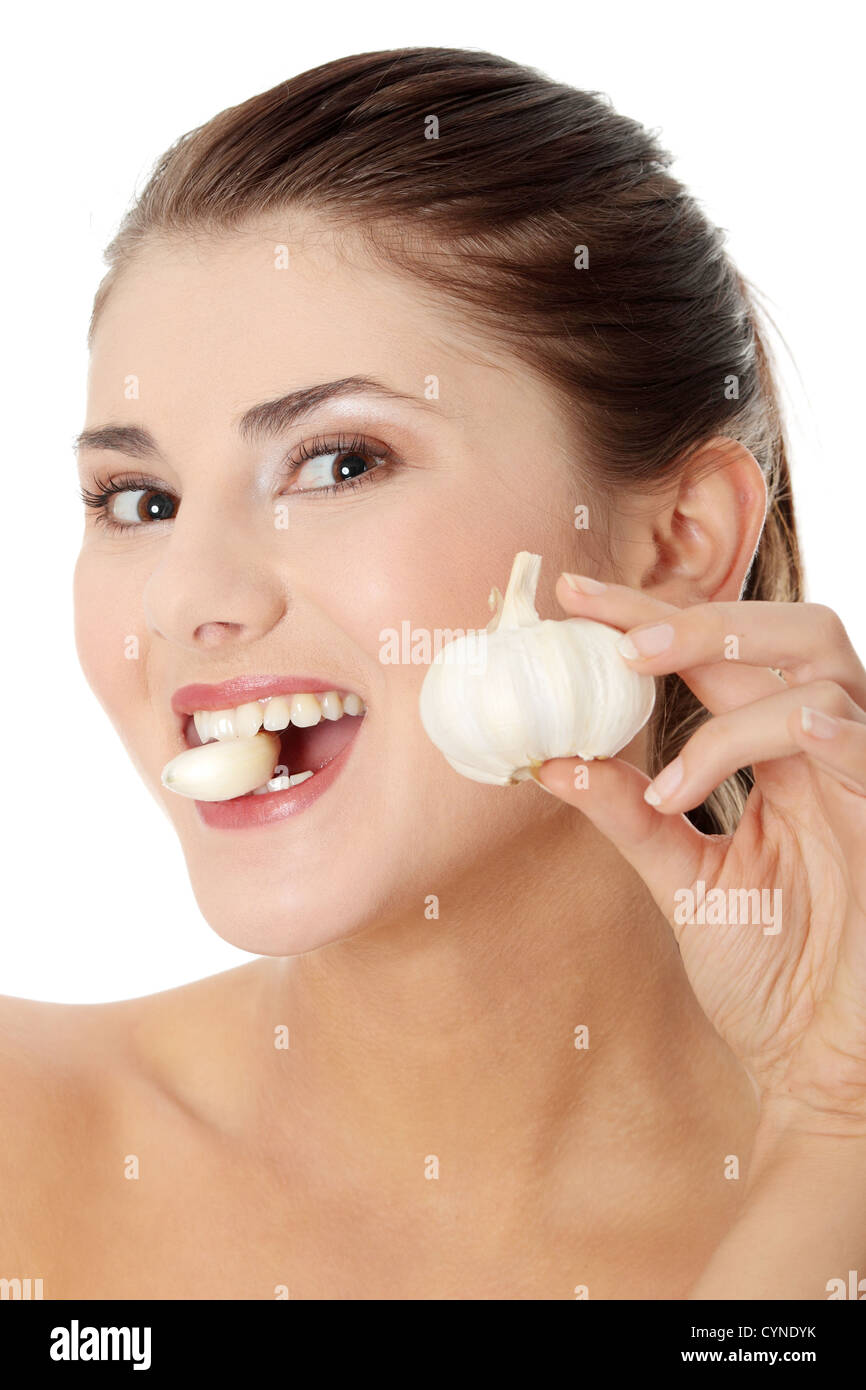 Young beautiful woman eating garlic. Healthy eating concept. Natural ...
