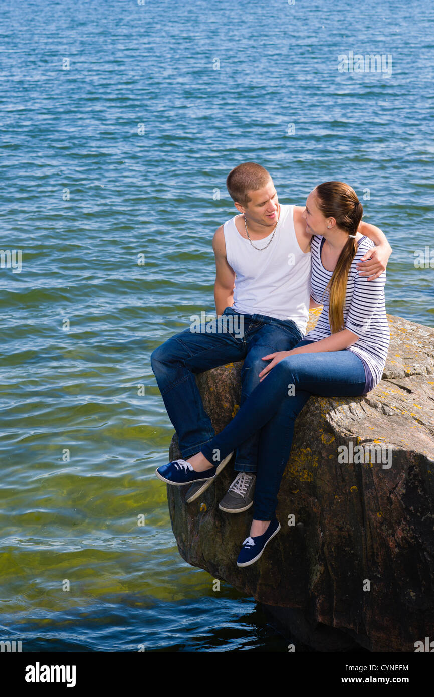 Young lovers looking and hugging each other on big rock Stock Photo - Alamy