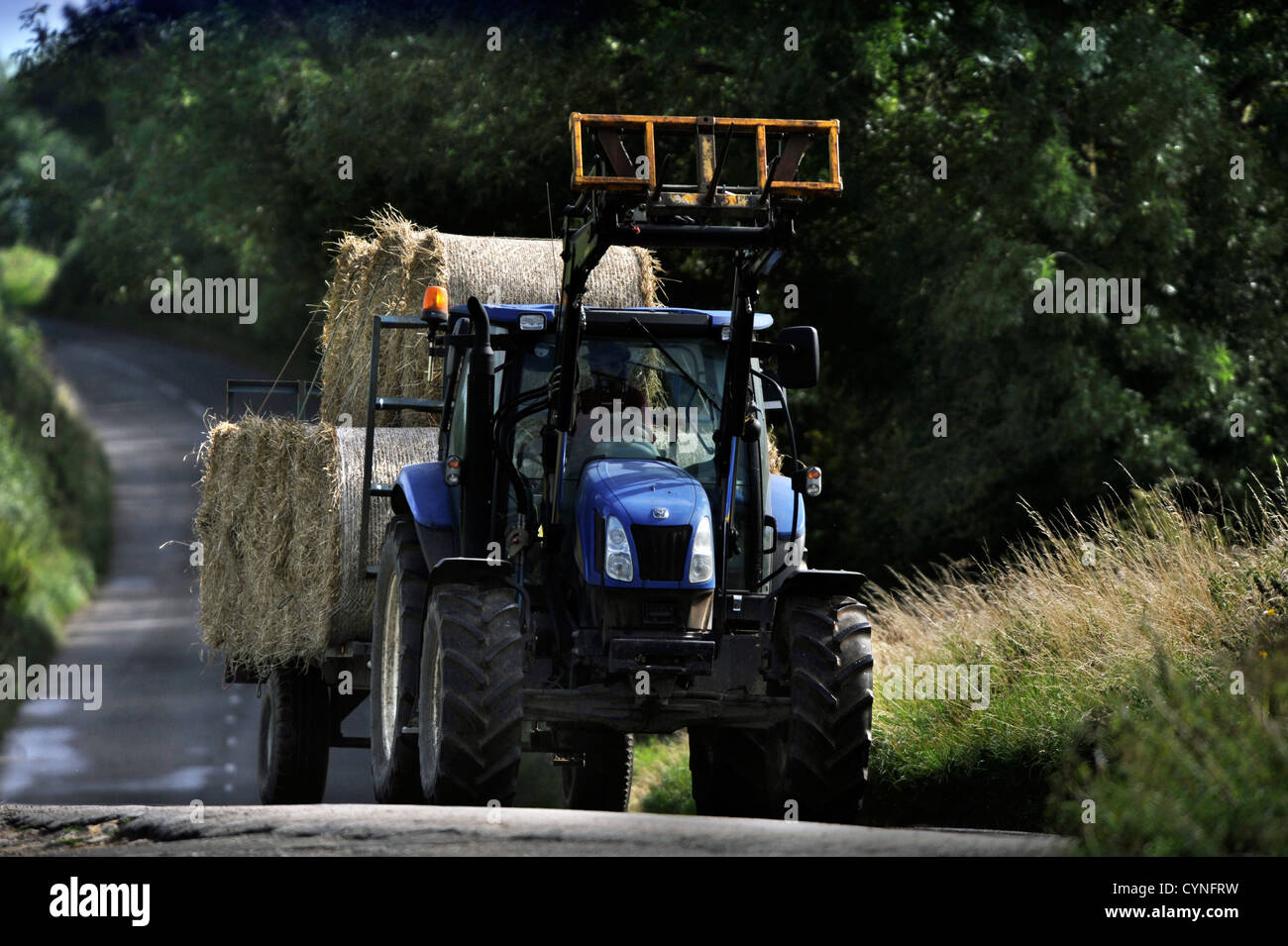 Tractor making straw bales in hi-res stock photography and images - Alamy