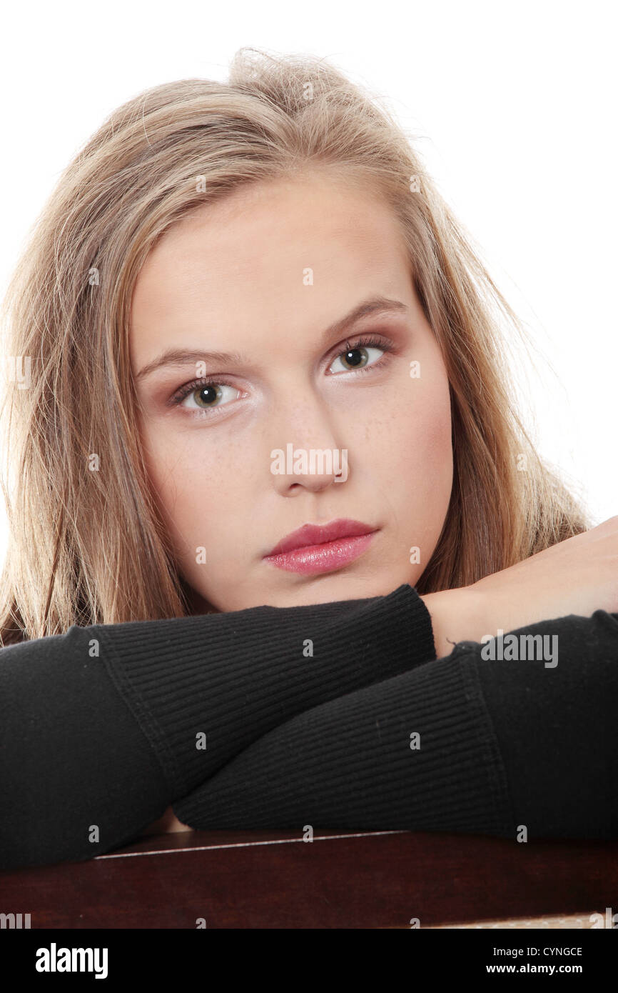 A worried and afraid young woman sitting on chair. Isolated Stock Photo ...