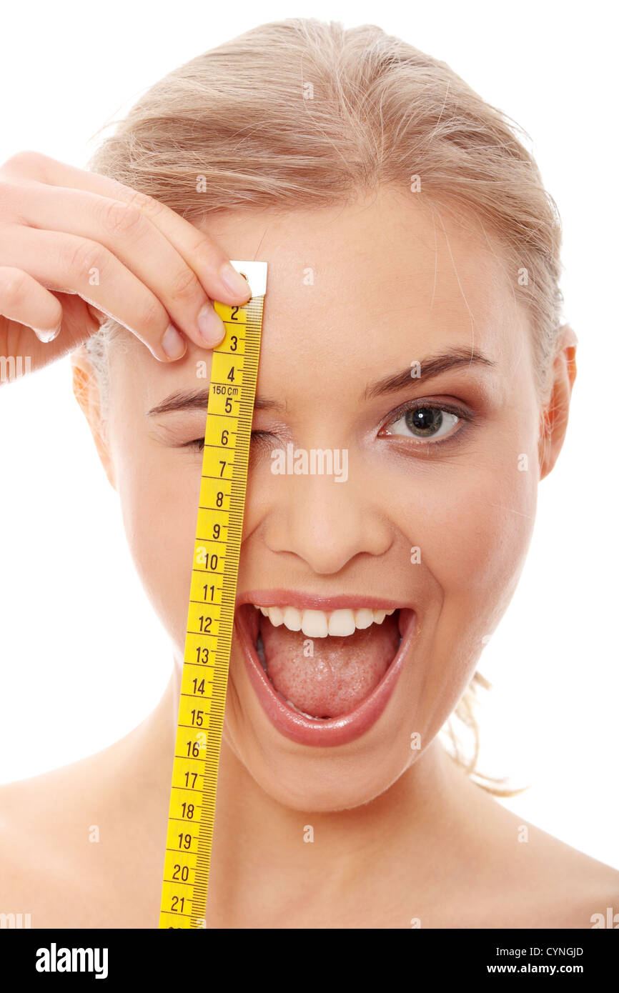 Beautiful young caucasian woman measuring her body with tape, isolated ...