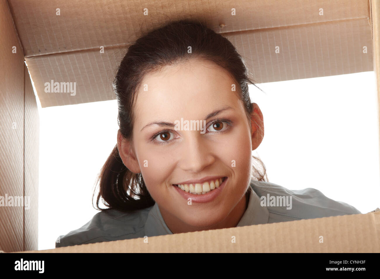 Thinking inside a box. Young business woman in cardboard box, isolated ...