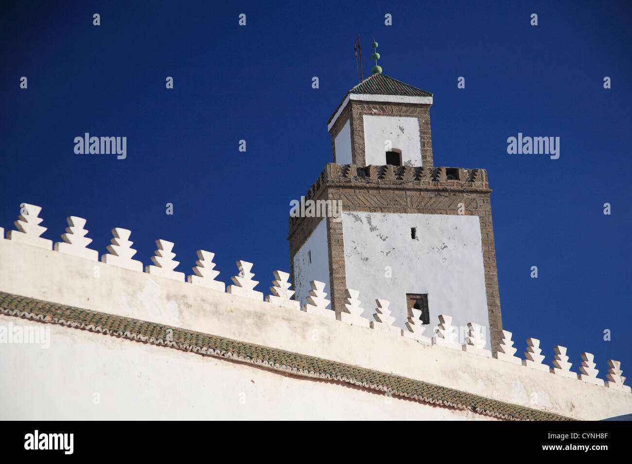 Prayer tower of mosque with white wall in front Stock Photo - Alamy