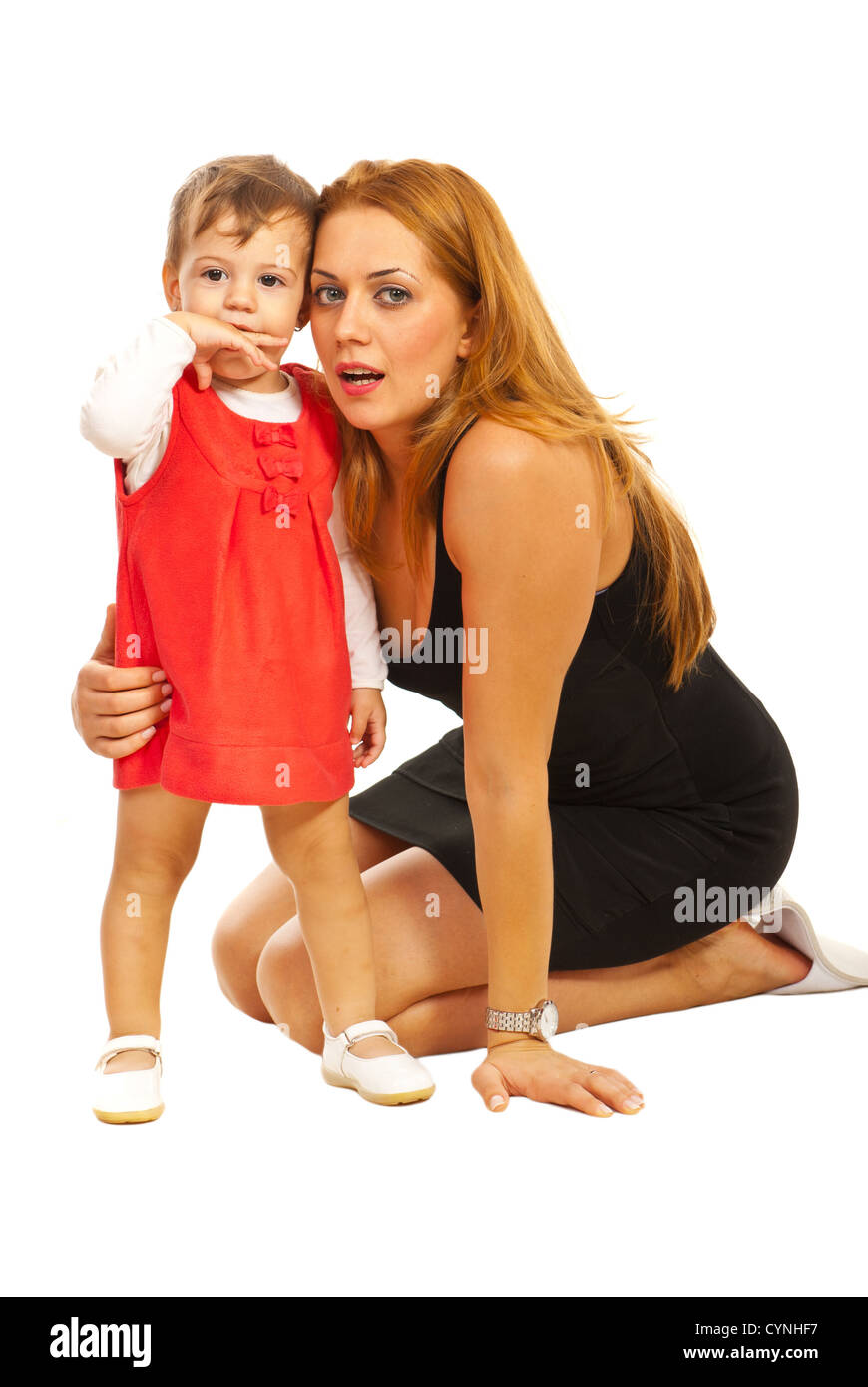 Elegant mother and girl sitting on floor isolated on white background ...