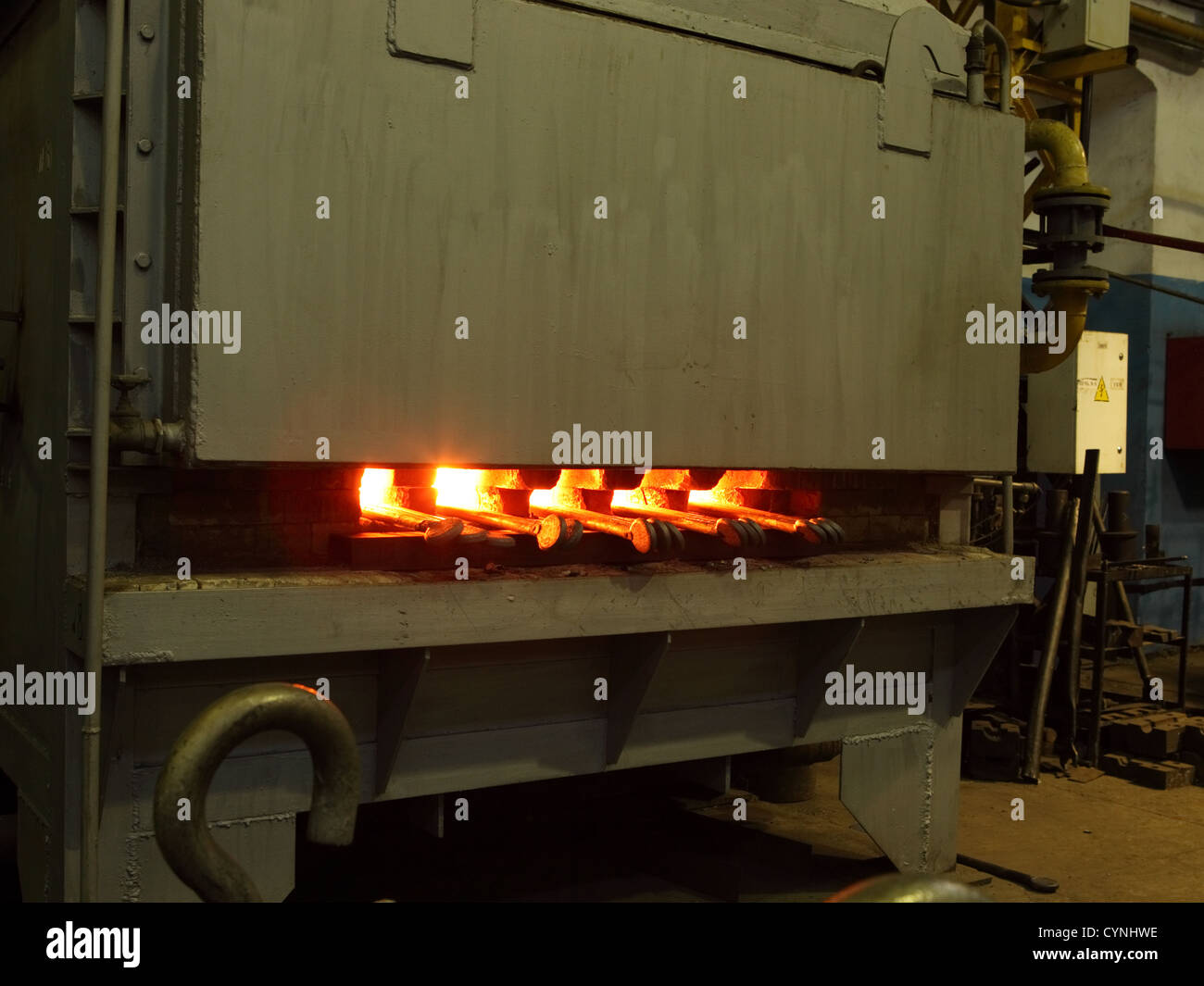 Factory scene with industrial machine blowing flames, metallurgic ...