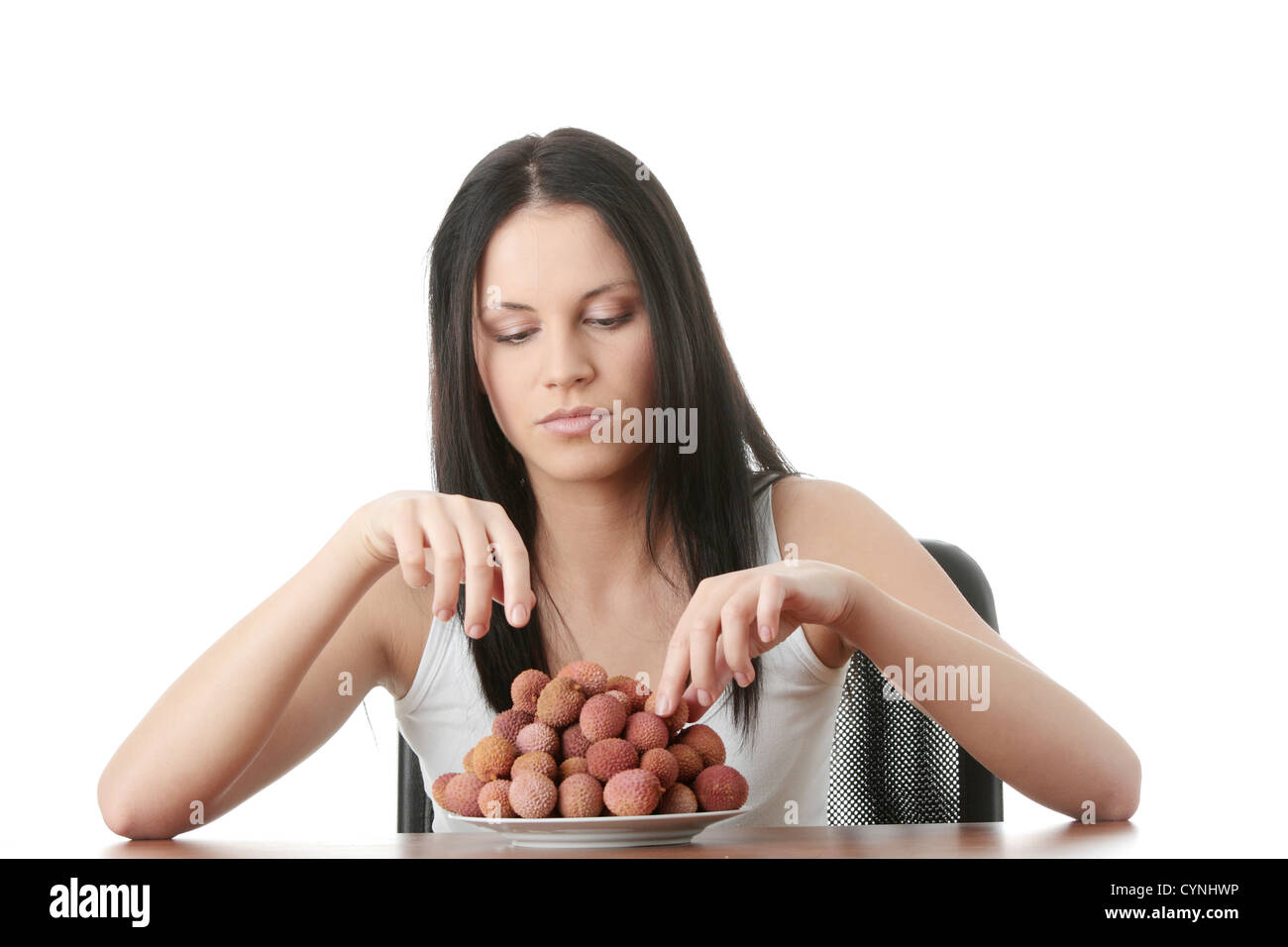 Young beautiful caucasian woman eating litchi fruits, isolated on whiet ...