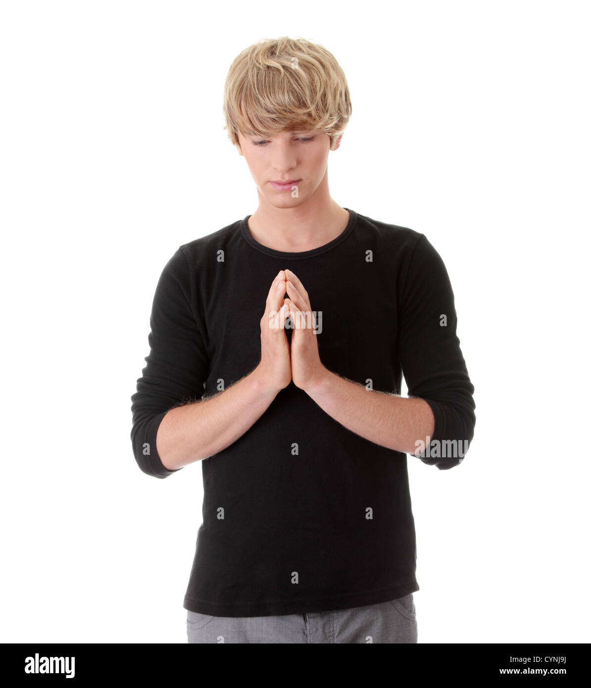 Young man with palms together, praying. Isolated on white background ...