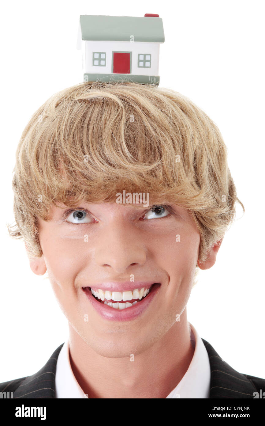 Young handsome business man with house model on head- real estate Stock ...