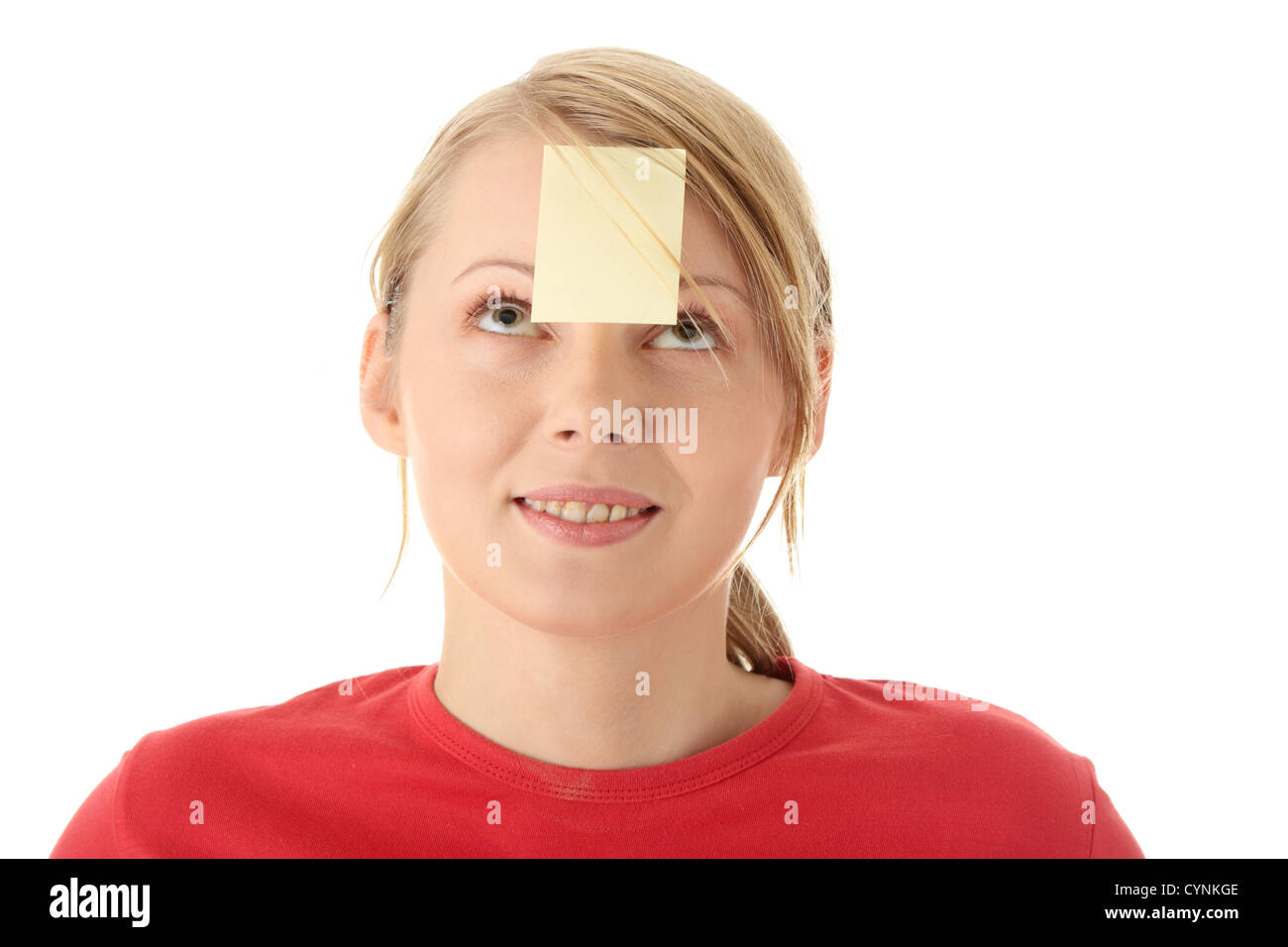 Young woman in red tshirt with yellow sticky note on forehead. Isolated ...