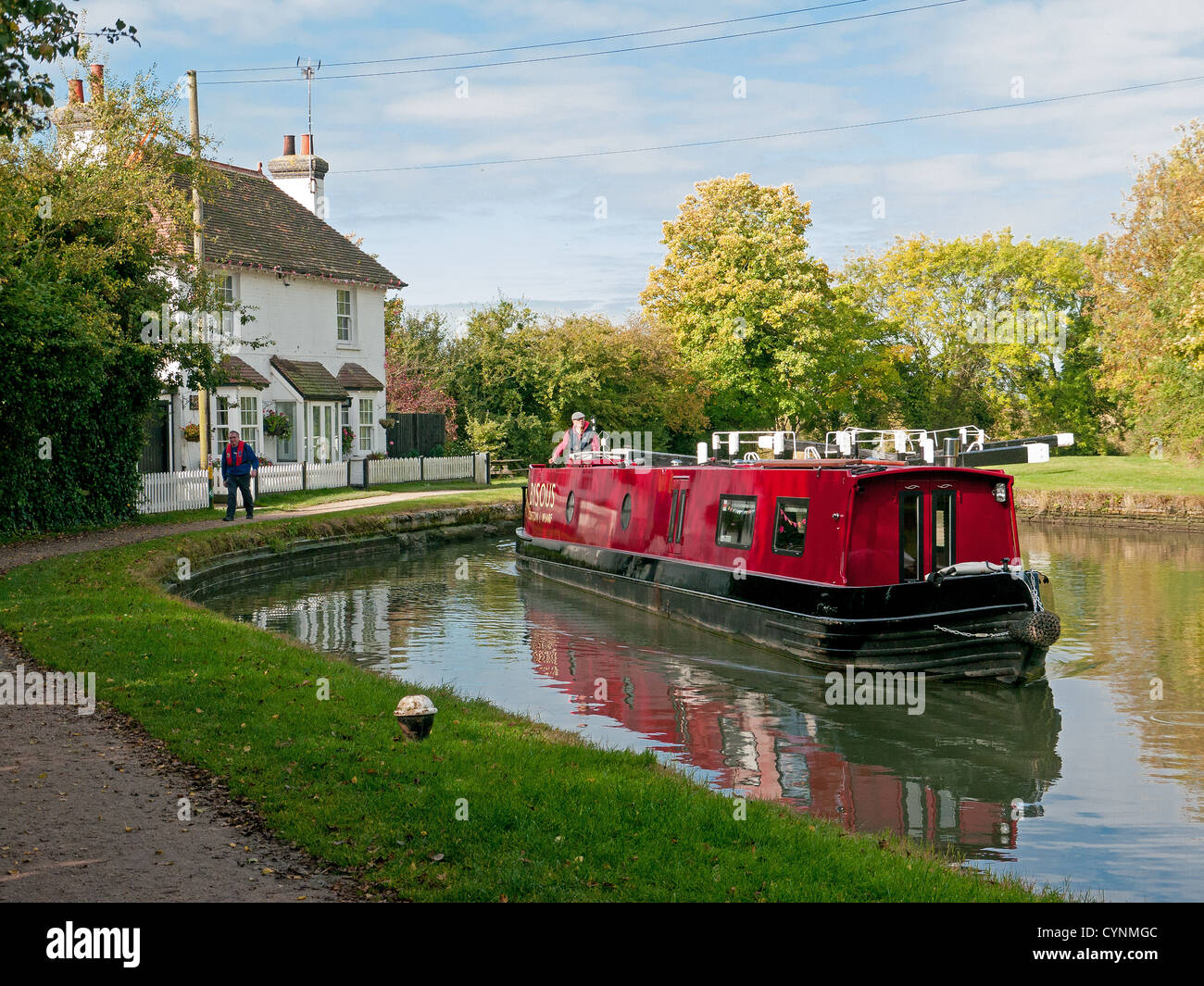 Red Narrow boat and lock keepers lodge on the Grand Union Canal at ...