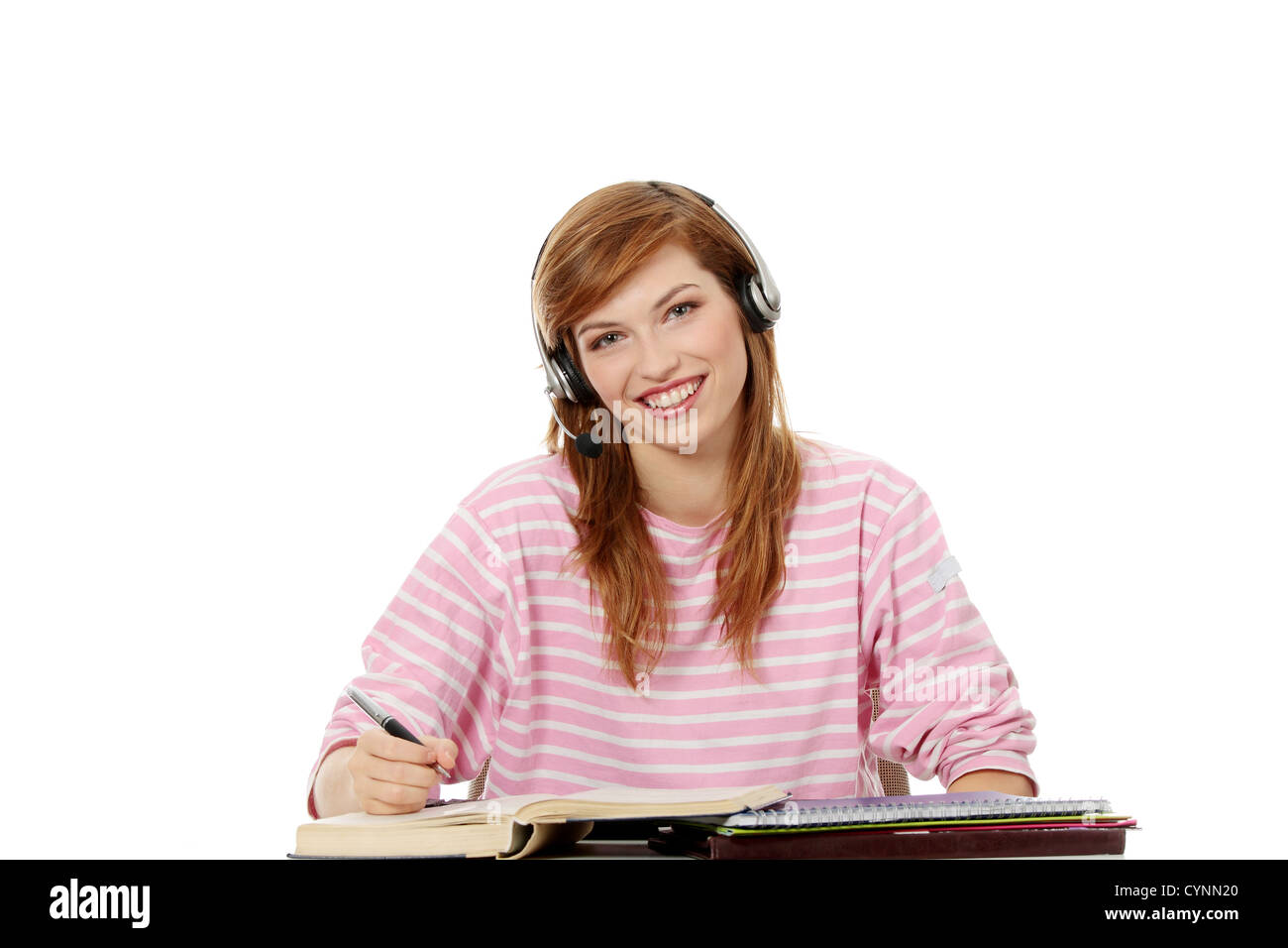 Teen girl learning at the desk (e-learning concept), isolated on white ...