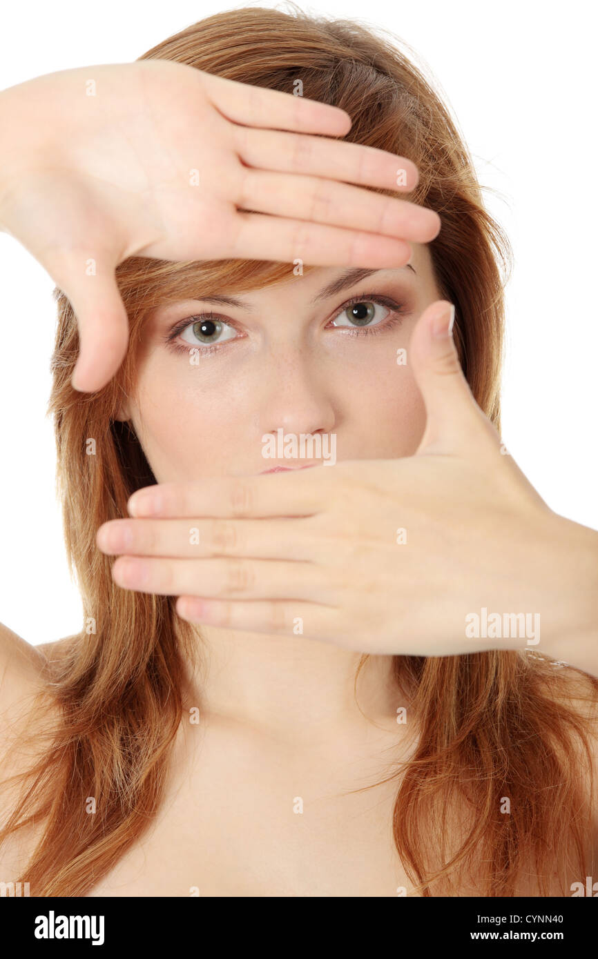 Closeup of beautiful woman making frame on her face with her hands ...