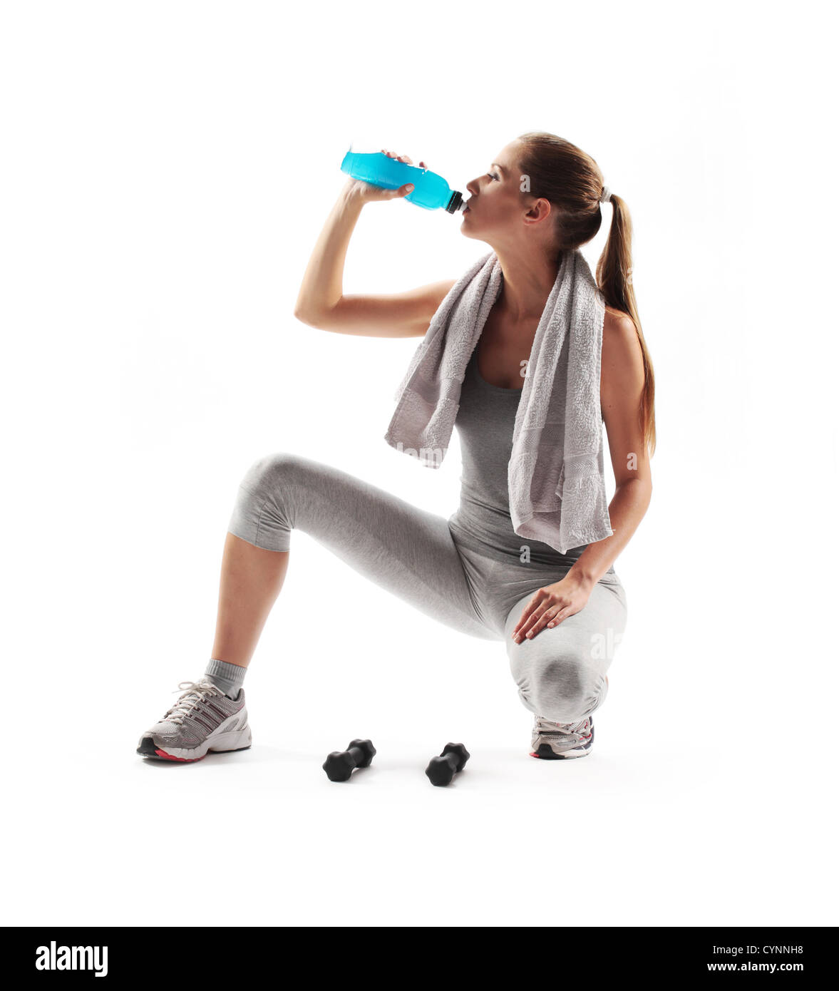 Thirsty young woman drinking after fitness workout Stock Photo - Alamy