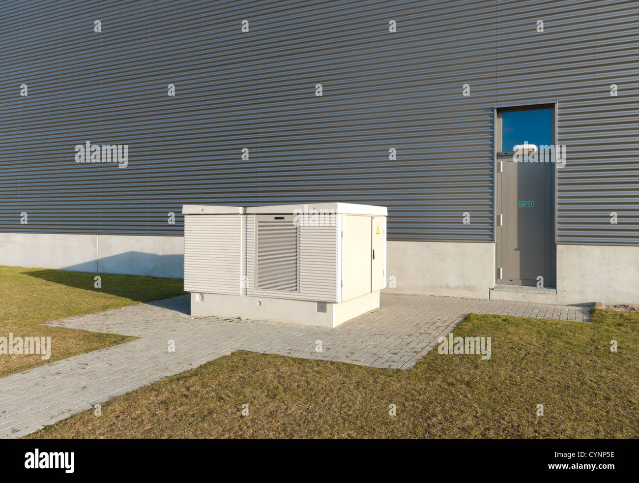 small transformer house next to an industrial warehouse Stock Photo - Alamy