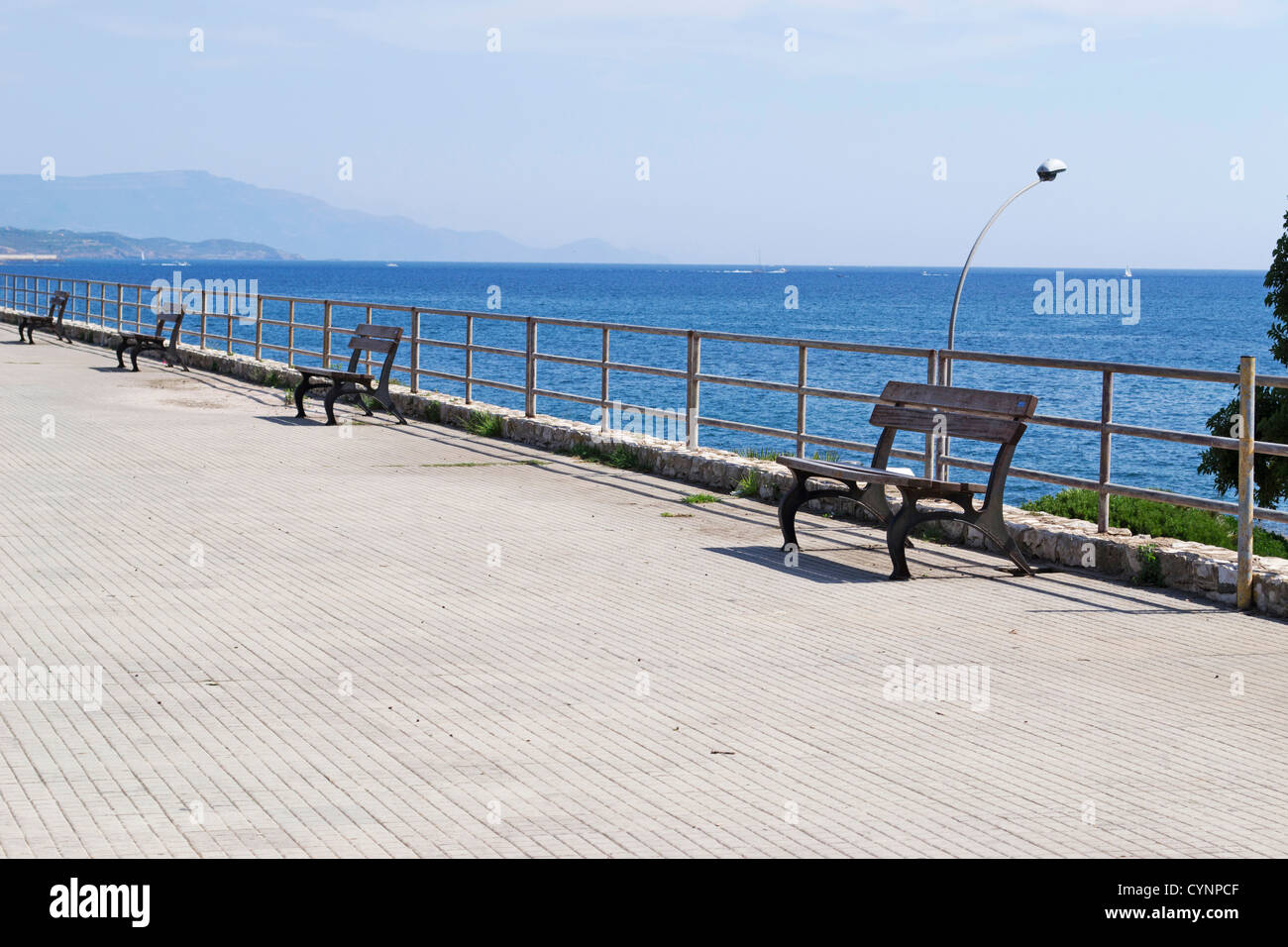 benches in line on the boardwalk Stock Photo - Alamy