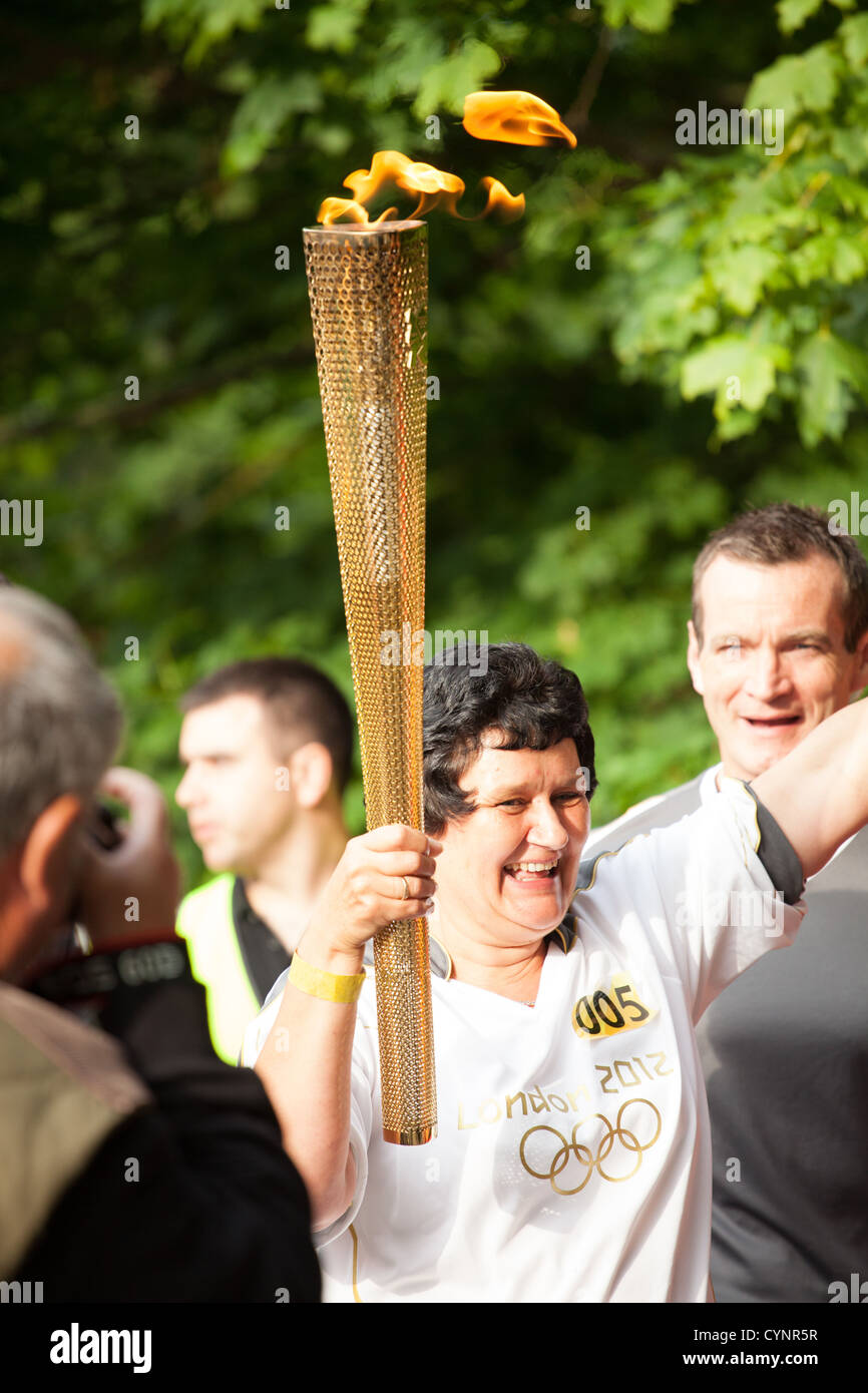Woman waving to crowd holding Olympic Torch - The Olympic Torch Relay ...