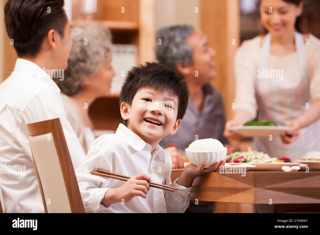 Happy family enjoying meal time Stock Photo - Alamy