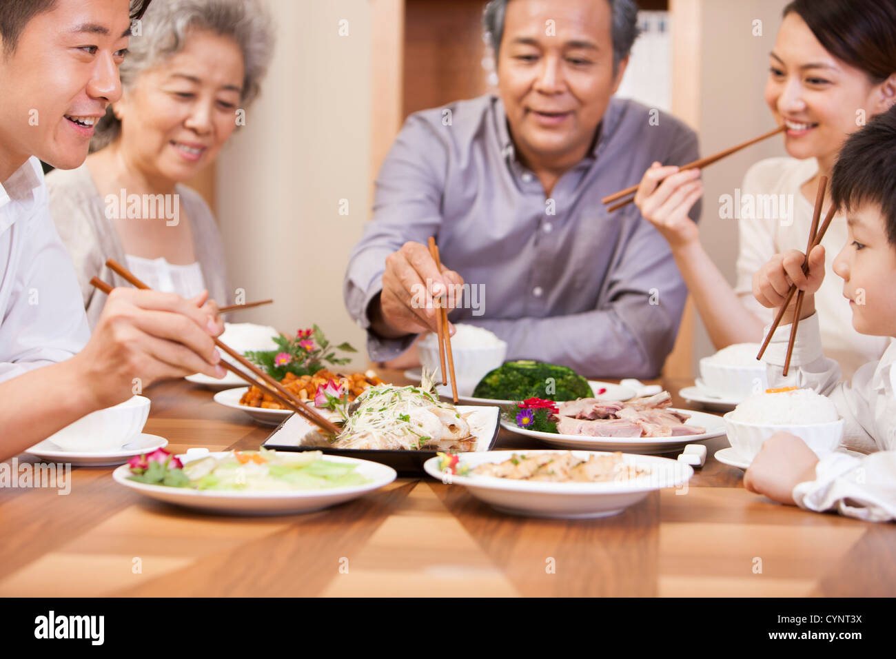 Happy family enjoying meal time Stock Photo - Alamy