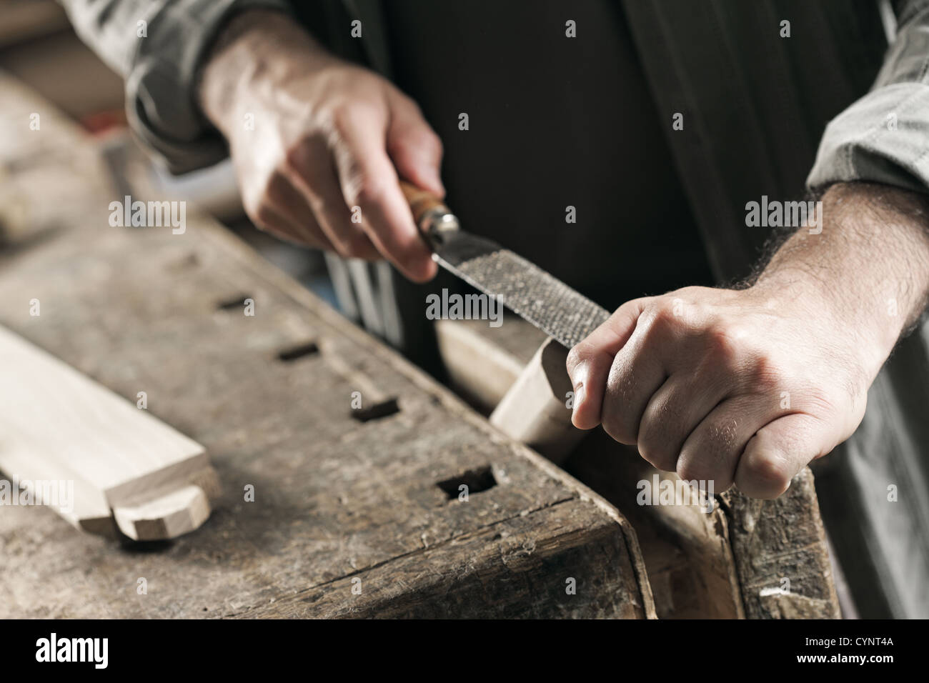 Carpenter working on a piece of wood with a file Stock Photo - Alamy
