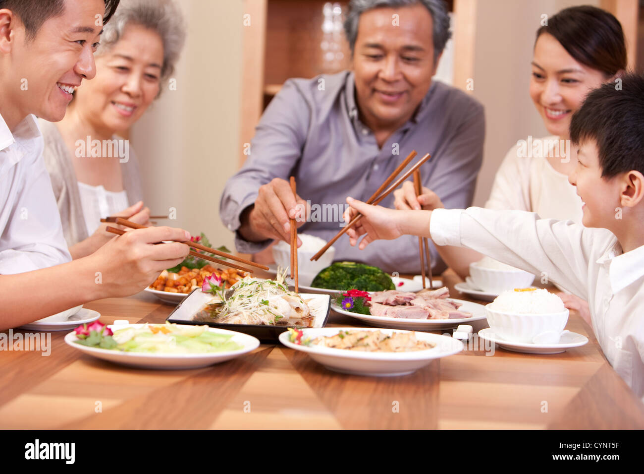 Happy family enjoying meal time Stock Photo - Alamy