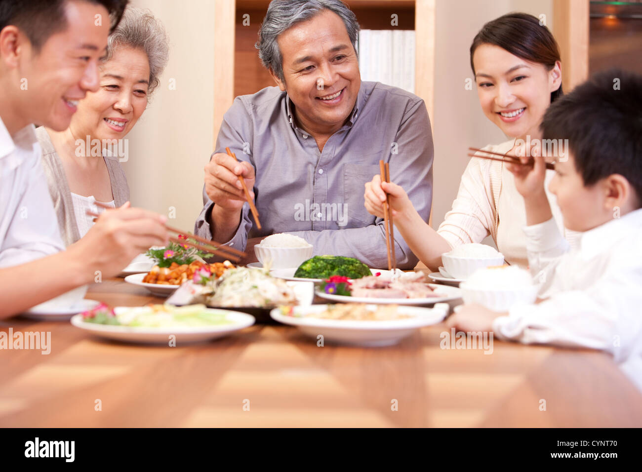 Happy family enjoying meal time Stock Photo - Alamy