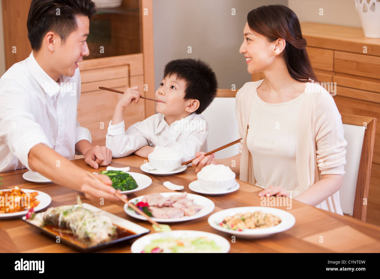 Happy family enjoying meal time Stock Photo - Alamy