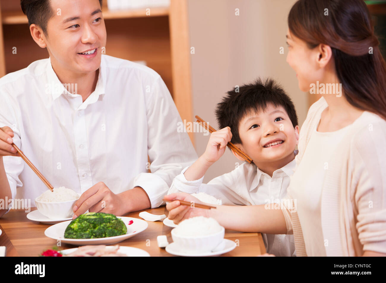 Happy family enjoying meal time Stock Photo - Alamy