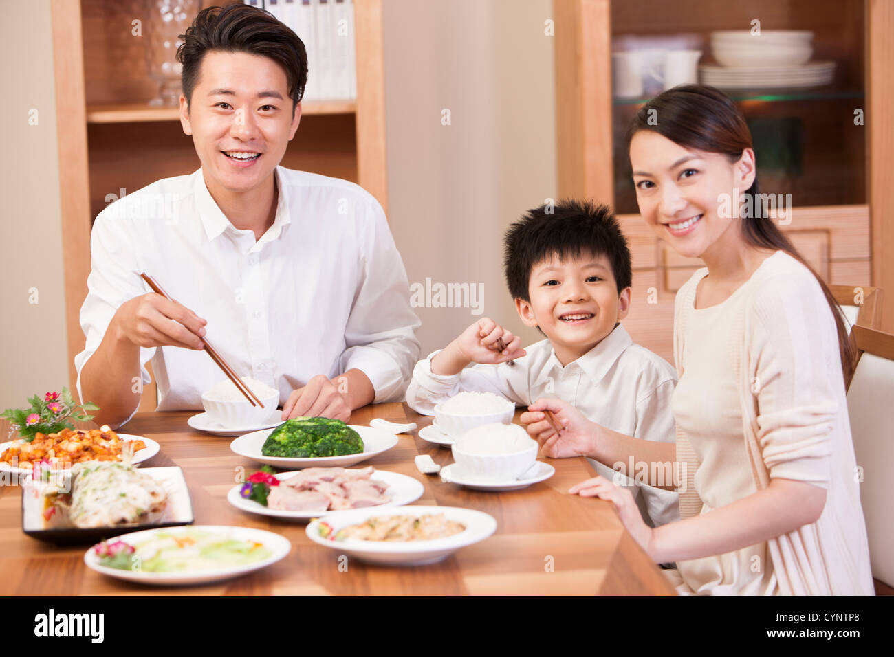 Happy family enjoying meal time Stock Photo - Alamy