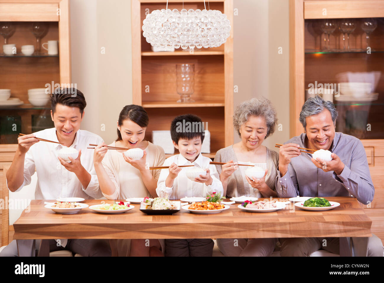 Happy family enjoying meal time Stock Photo - Alamy