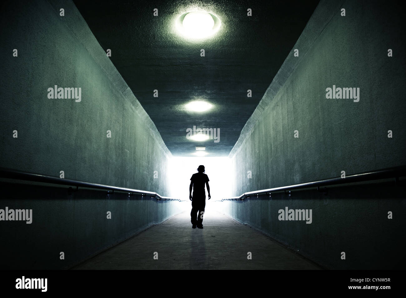 Youth walking into the light Stock Photo - Alamy