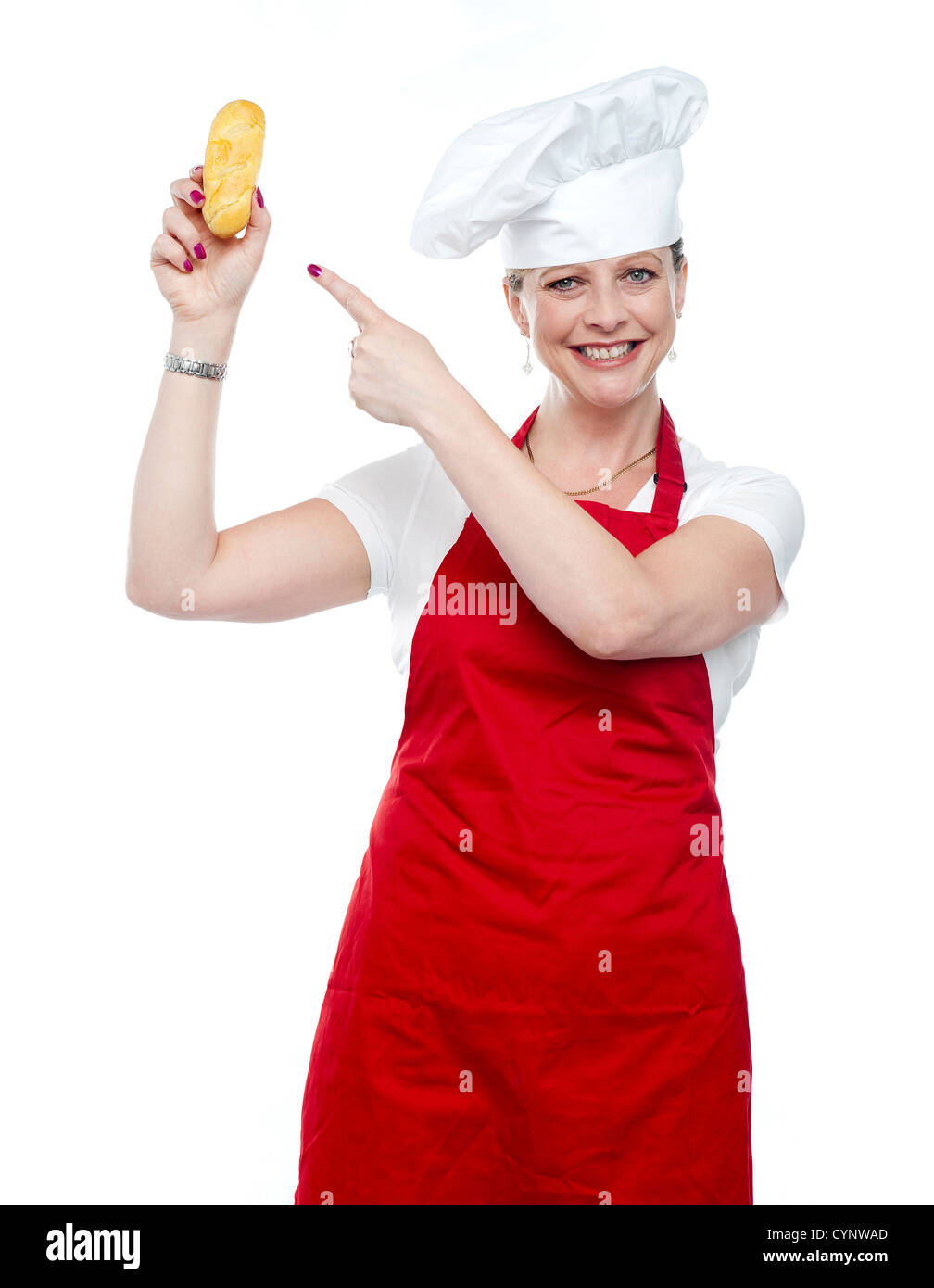 Experienced female cook pointing at bread isolated against white ...