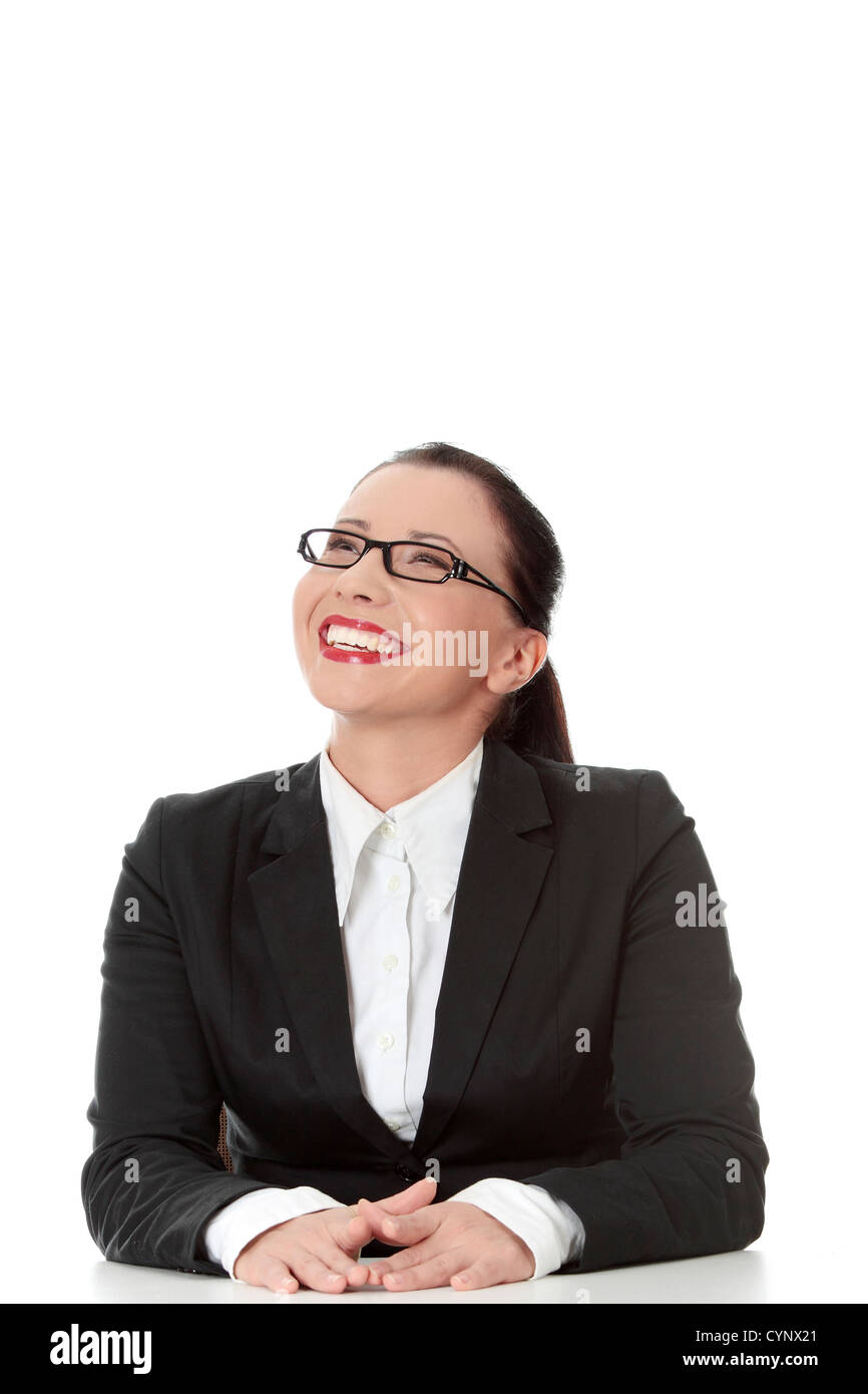 Young happy businesswoman behind the desk, looking up, isolated Stock ...