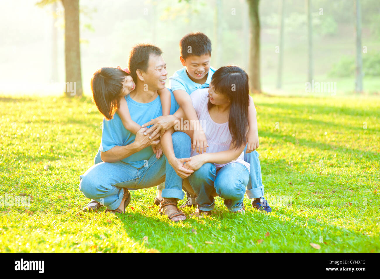 Happy Asian family having conversation at outdoor park Stock Photo - Alamy