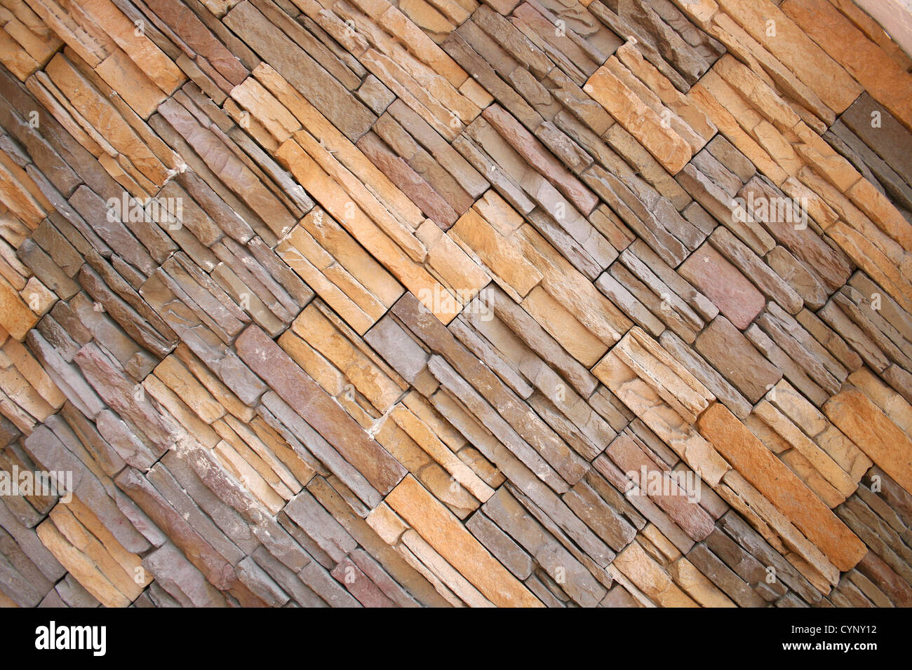 An angled narrow brick facade provides an abstract pattern of colors ...