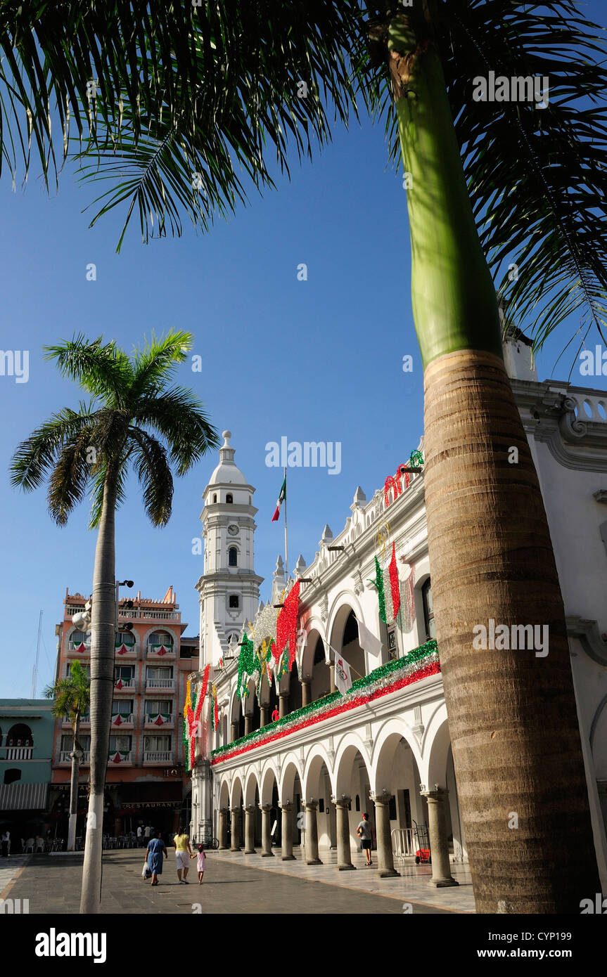 Palm trees in the zocalo and government buildings decorated with ...