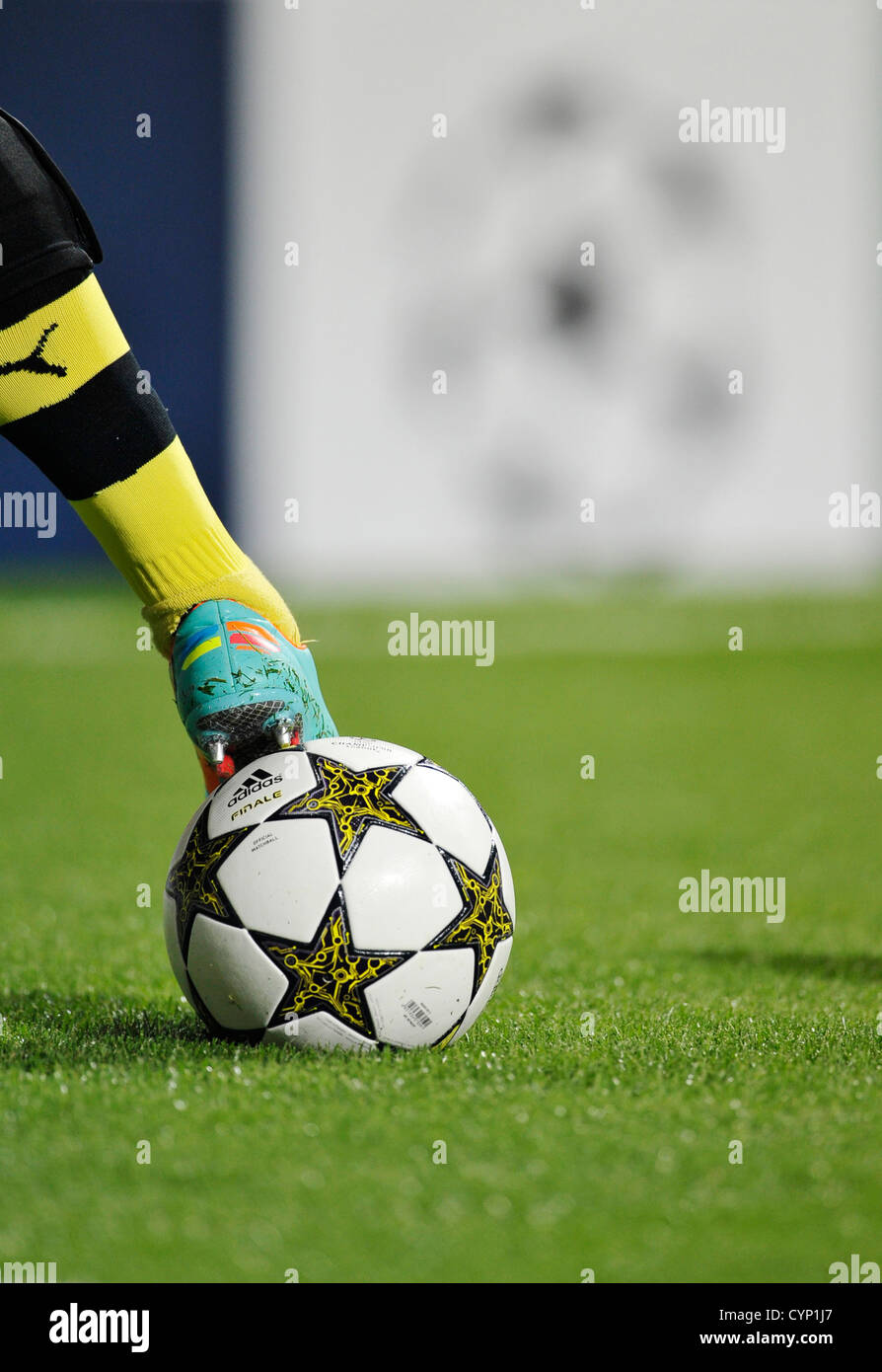 foot of a football player rests on UEFA Champions League ball Adidas ...
