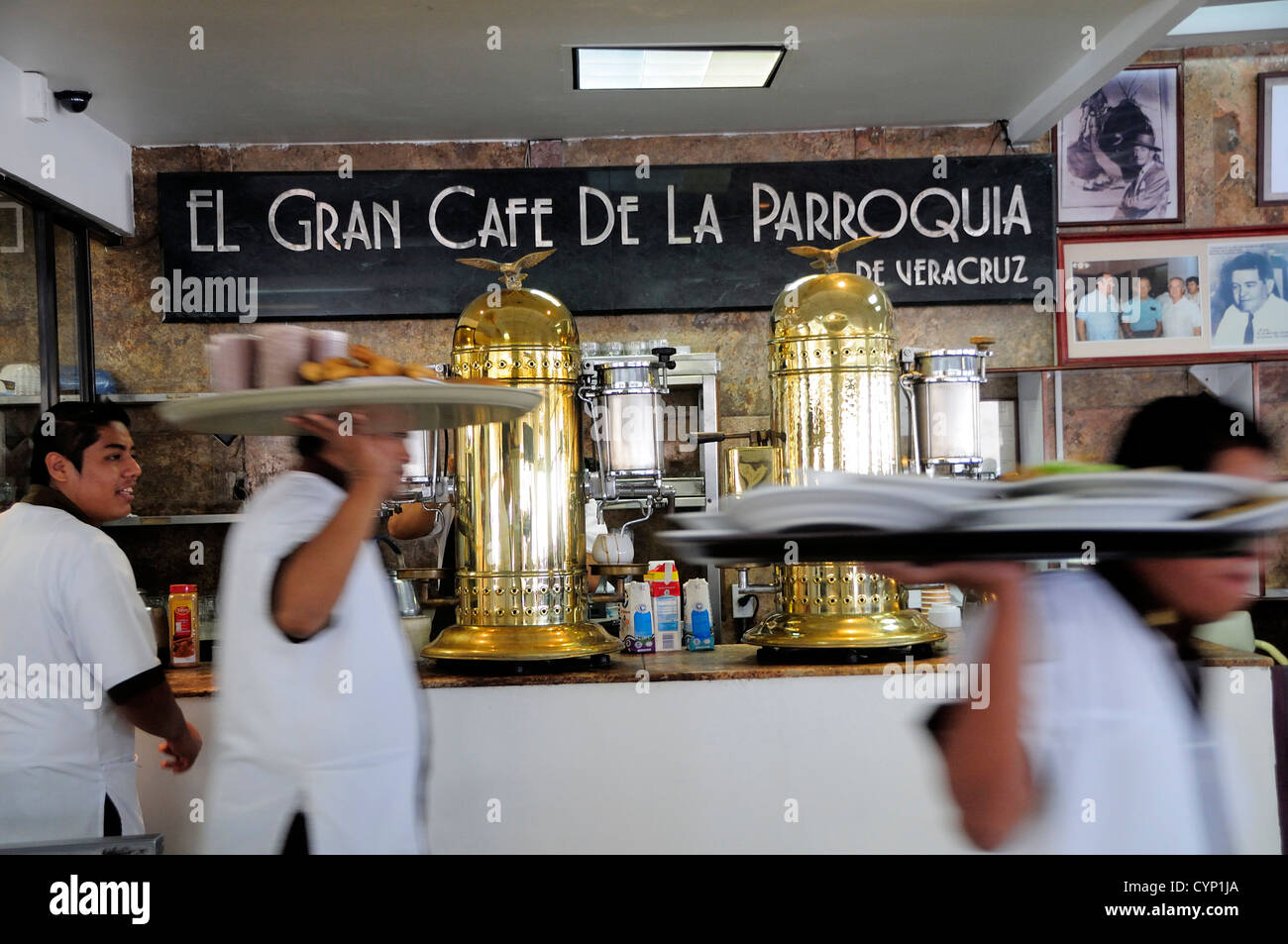 Cafe El Gran Cafe de la Parroquia interior with waiters carrying laden ...